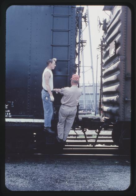 Workers riding L&NE boxcar ladder in June 1962 | The Nickel Plate Archive