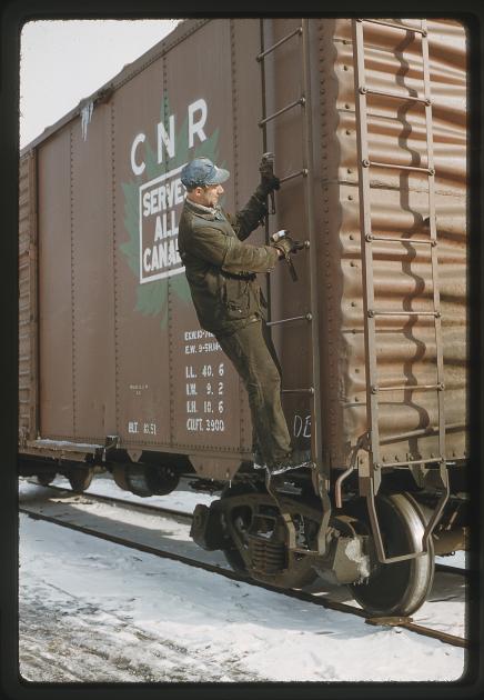 Worker on ladder of CN boxcar in March 1960 | The Nickel Plate Archive