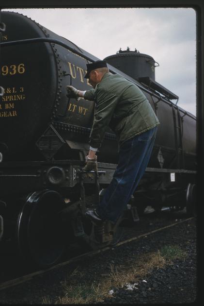 Worker riding tank car | The Nickel Plate Archive