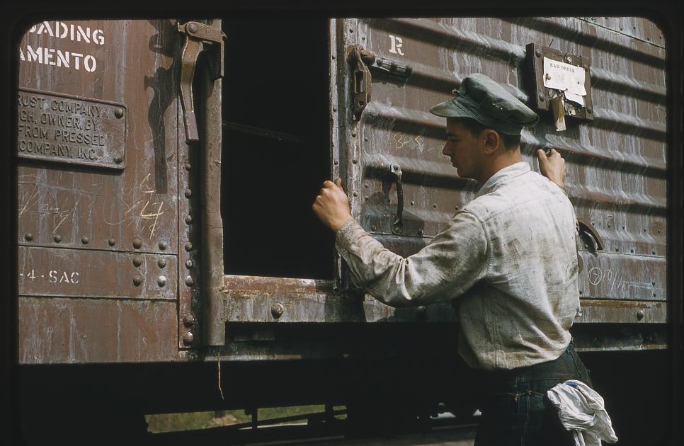 Worker closing boxcar door | The Nickel Plate Archive
