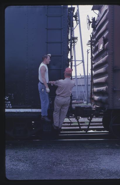 Workers riding boxcar ladder in May 1962 | The Nickel Plate Archive